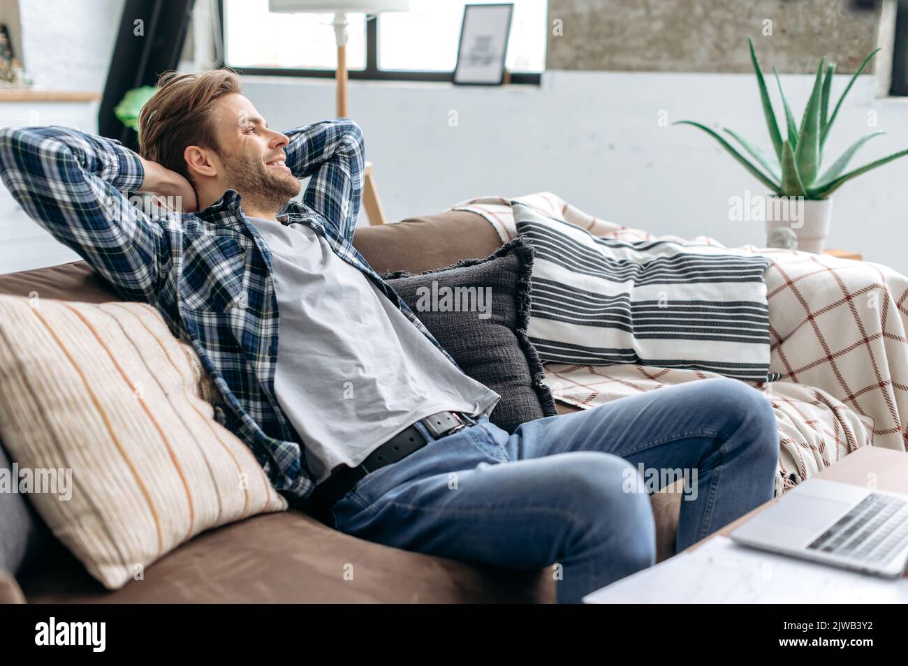Relaxation at home. Satisfied positive calm stylish caucasian young man ...