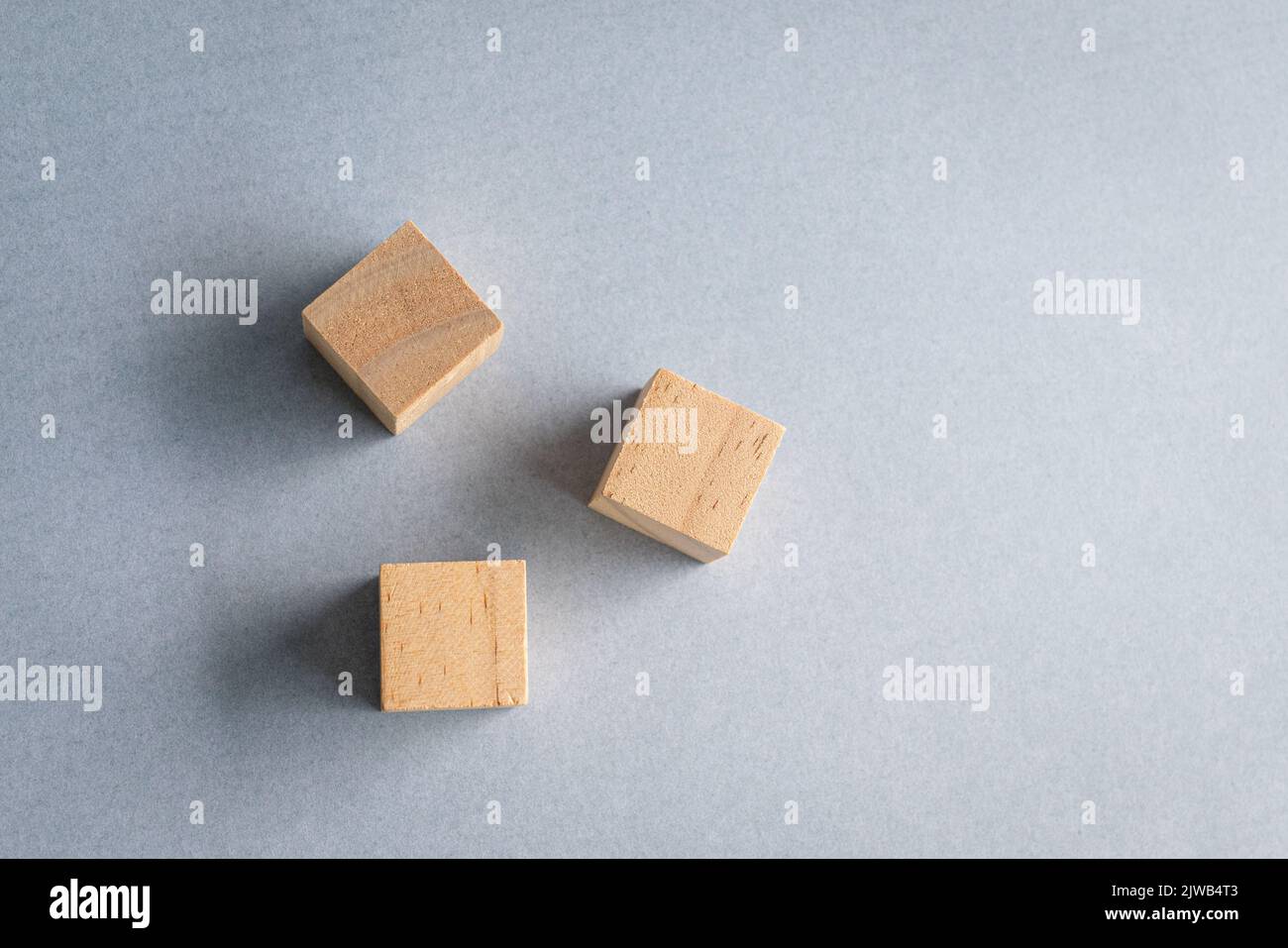 Three blank wooden cubes on top of table, top view. Free text and copy ...