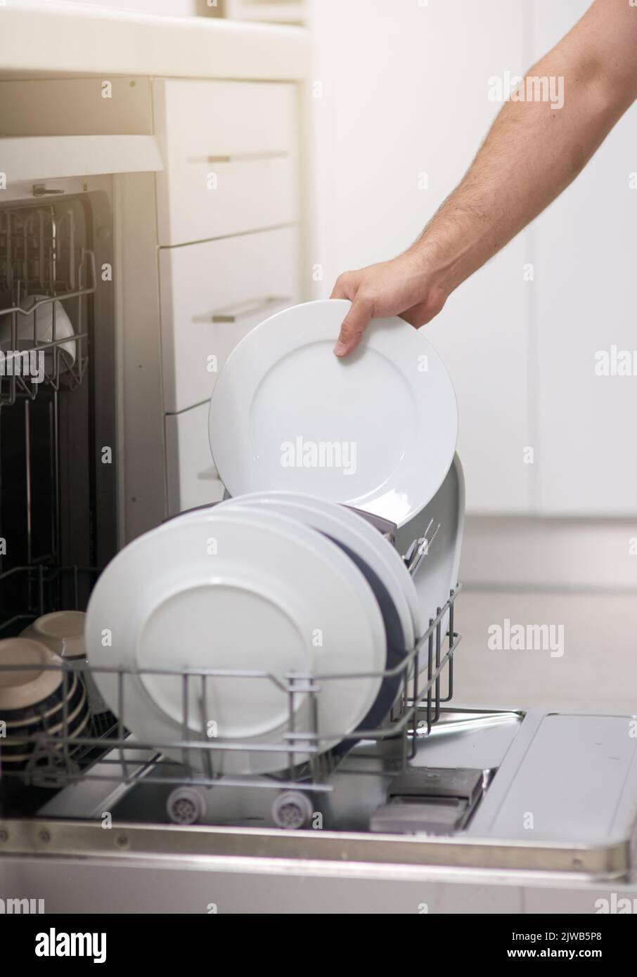 All clean and ready for the next meal. a dishwasher at home Stock Photo ...