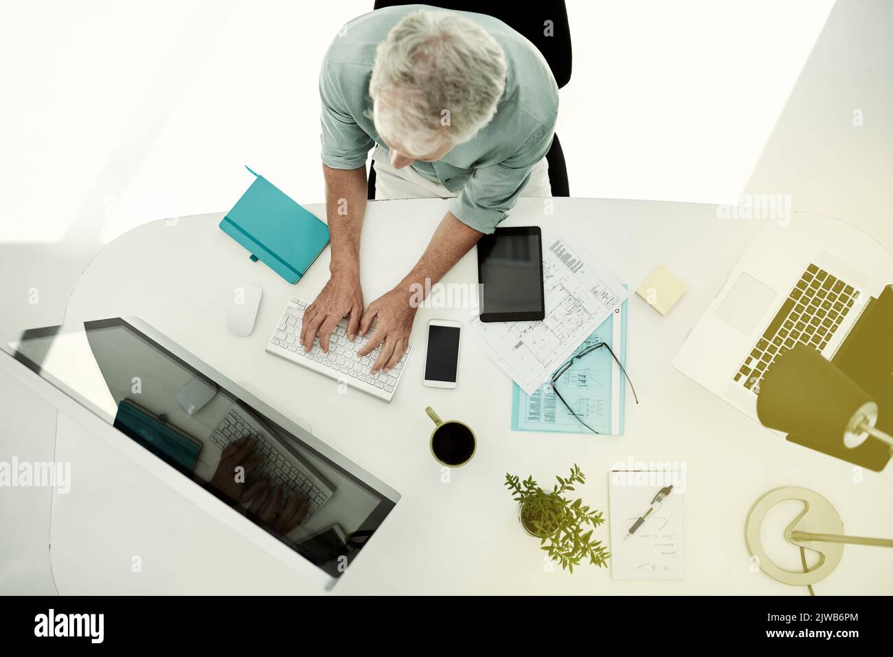 Hes a modern businessman in action. High angle shot of a mature ...