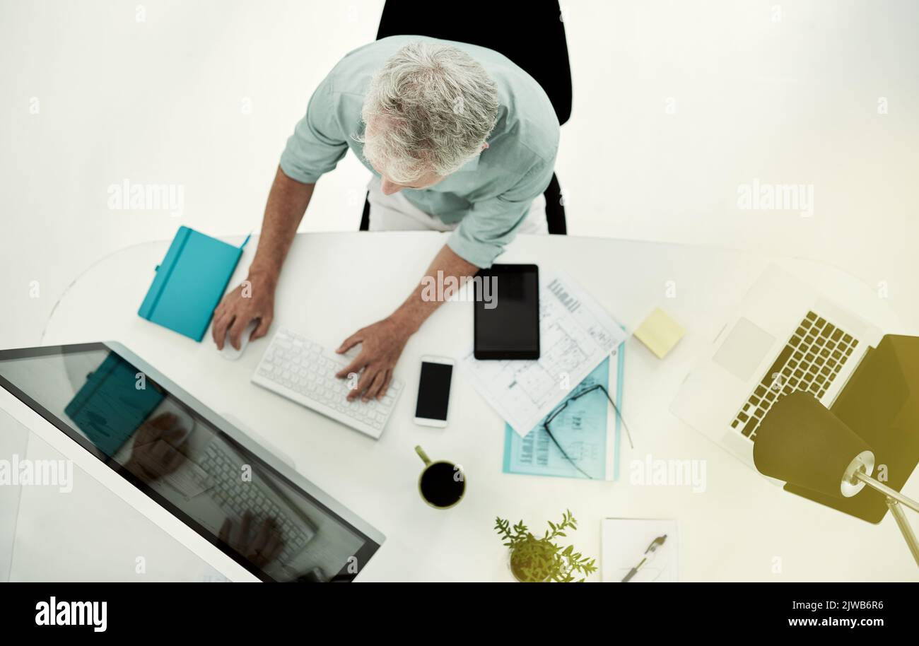 Getting down to business. High angle shot of a mature businessman ...