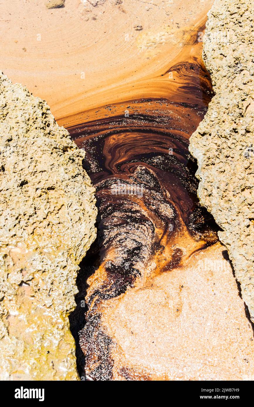 The sea beach and the rocks are polluted with oil. A crude oil spill in ...