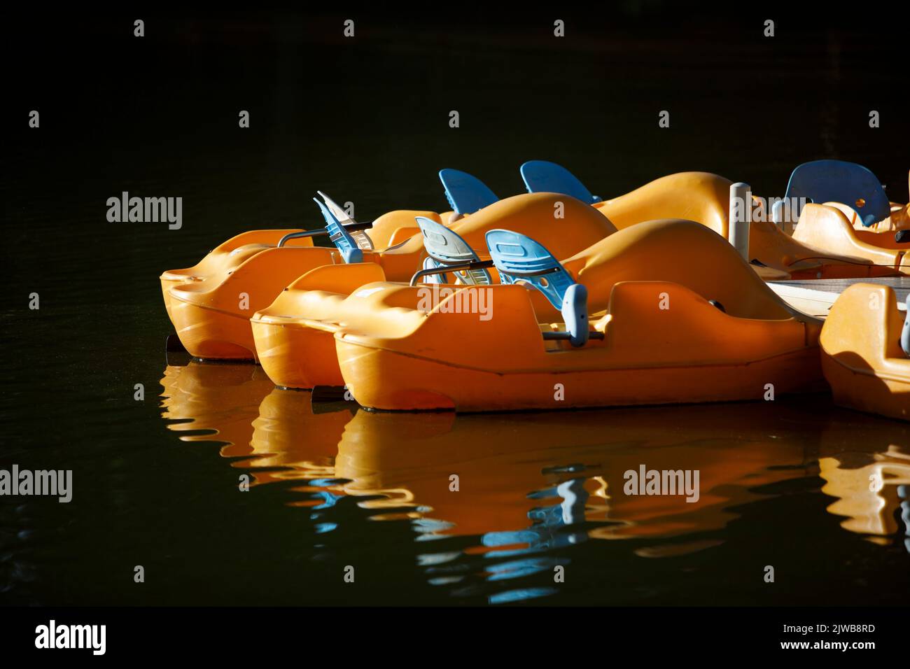 Yellow and Blue pedal boats floating in a lake at Shelby Farms Park ...