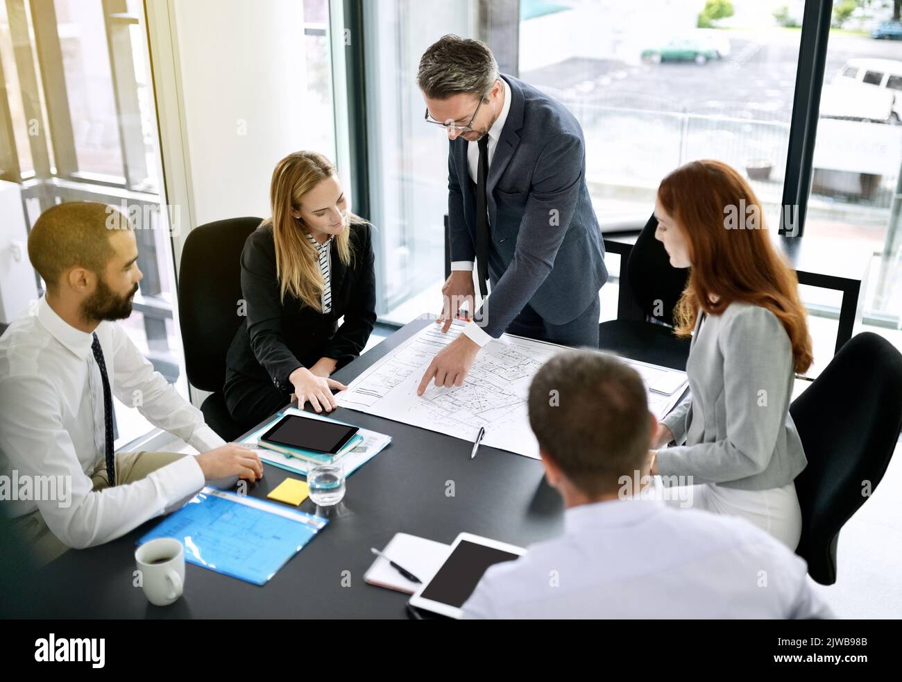 Finalizing plans for a new building. a team of architects going over a ...