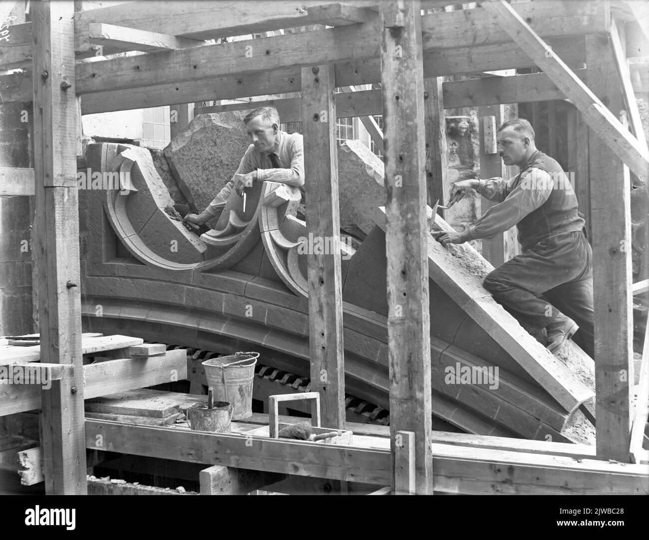 Image of two construction workers during the restoration of an air arch ...