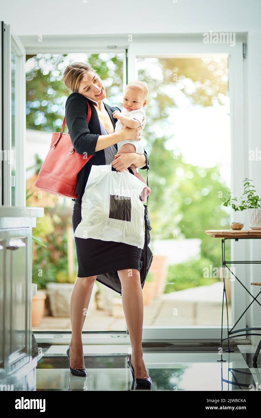 The reality of being a working Mom. a busy businesswoman carrying a ...