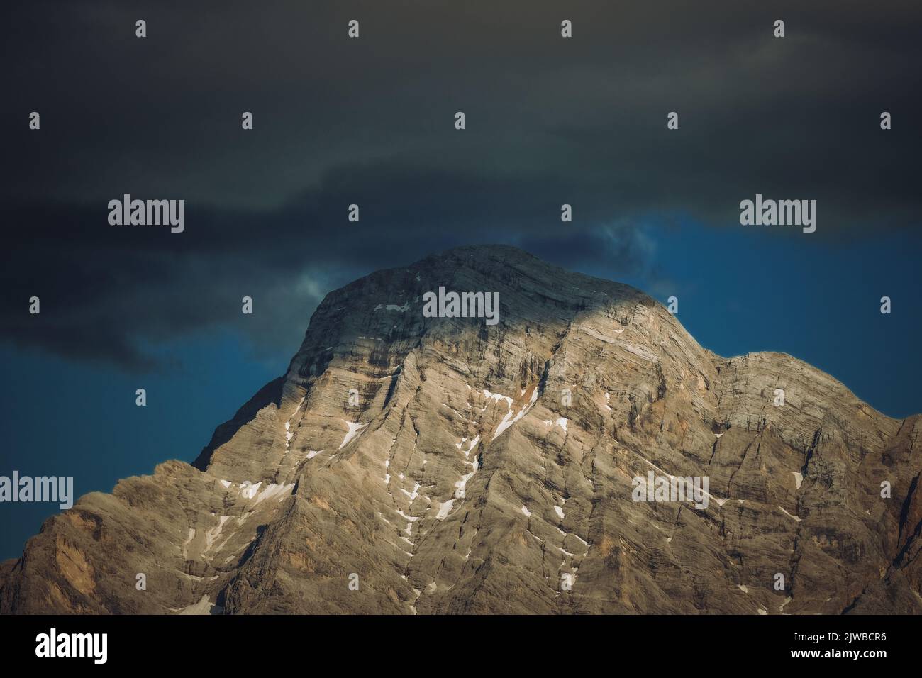 A huge dark rainy cloud over mountain's peak Stock Photo - Alamy