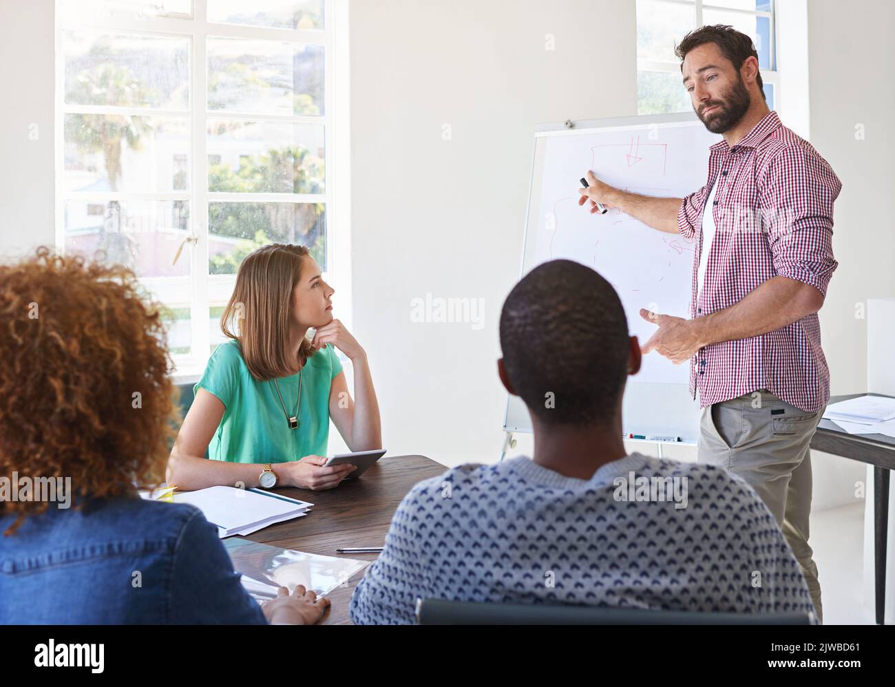 Take a look here for a second. a young businessman giving a ...