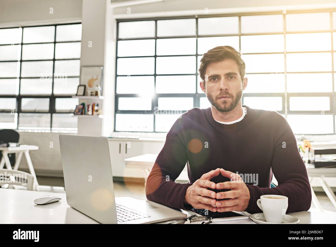 Success is serious business. Portrait of a young businessman working at ...