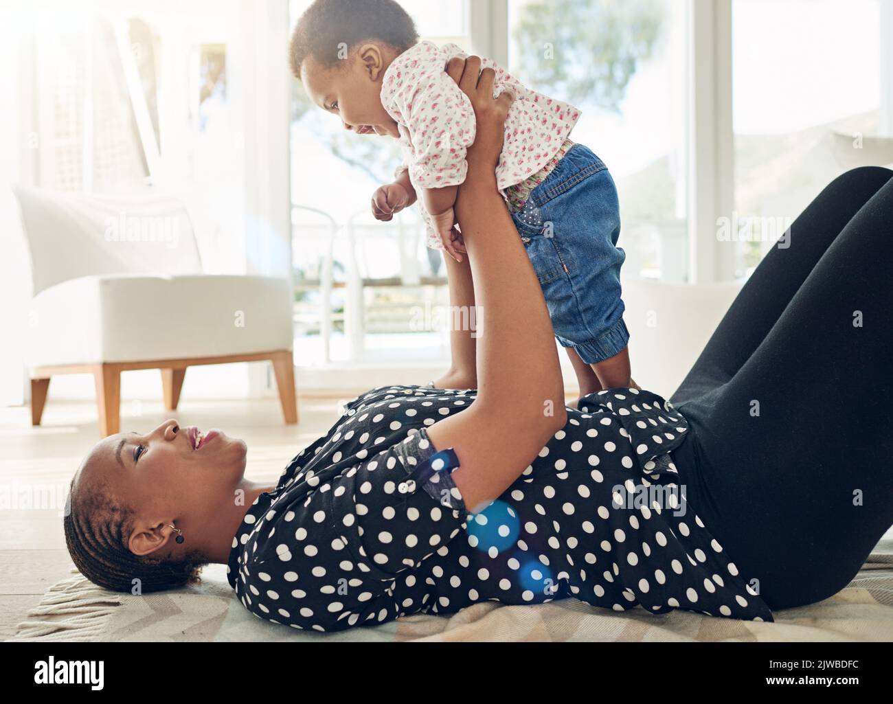 Shes just too precious. a mother holding her baby girl up in the air ...