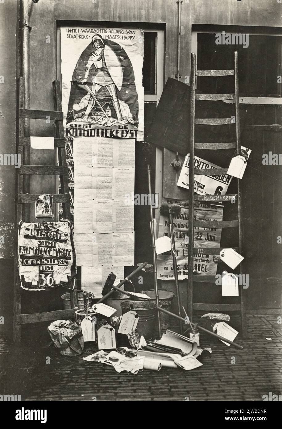 Image of a display of ladders and attributes for pasting posters, with ...