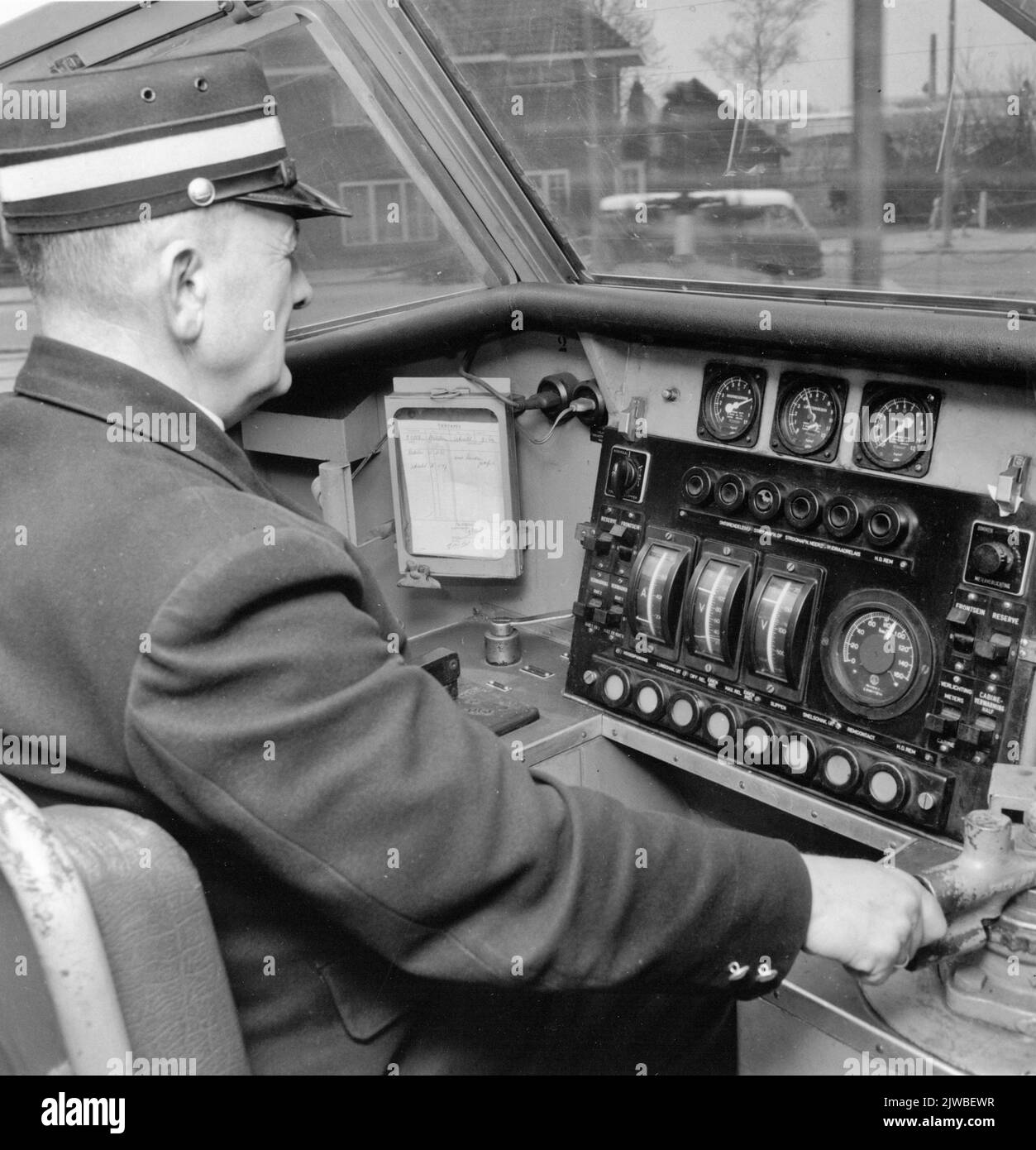 Image of a driver in the cabin (steering position) of an electric train ...