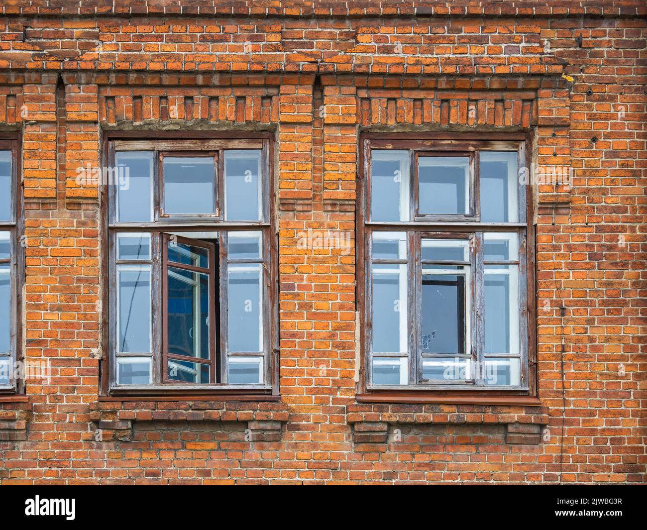 Two windows of the old mansion 19 century with brown bricks wall. Brick ...