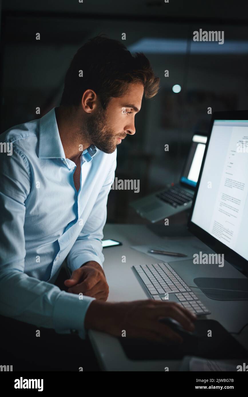 Got to make it a productive night. a young businessman working late on ...