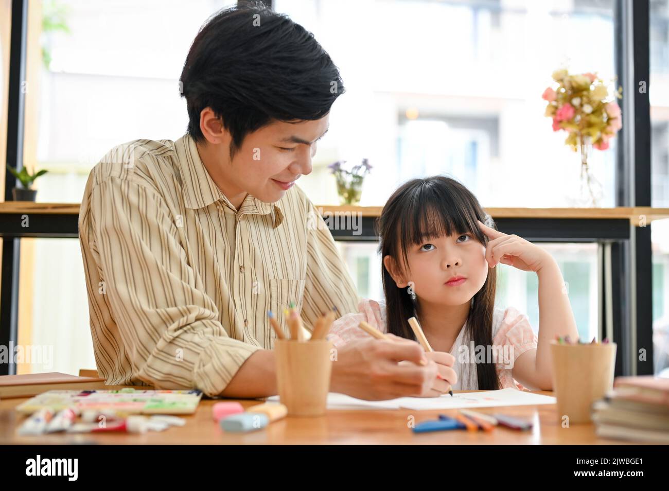 Smart and cute young Asian girl studying and practicing painting art ...