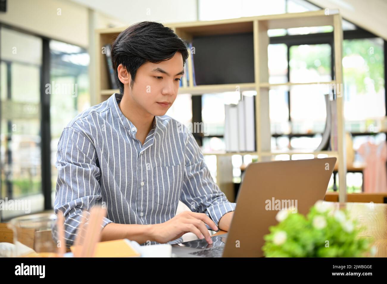 Handsome and smart young Asian male freelancer or businessman remote ...