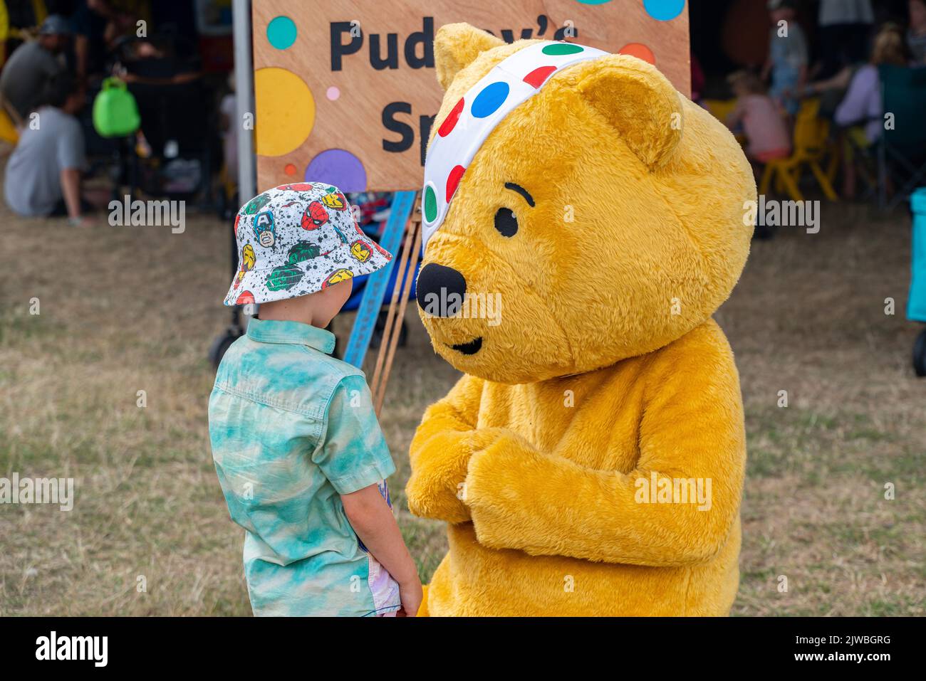 Pudsey Bear meets a child at the Car Fest South. Car- Fest South, main ...