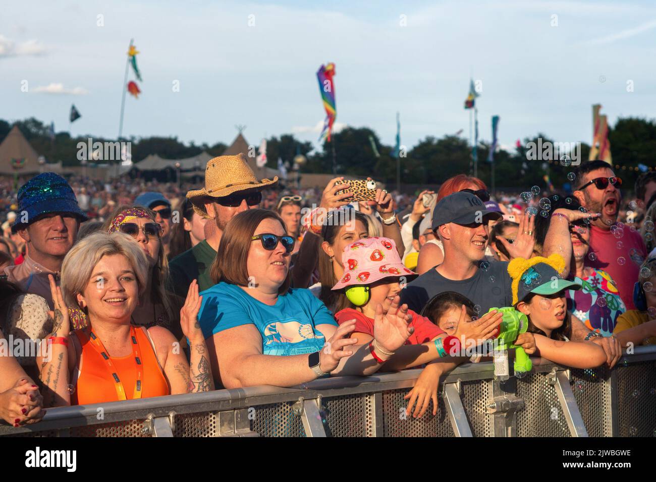 Festival goers seen enjoying themselves at the front of the barrier ...