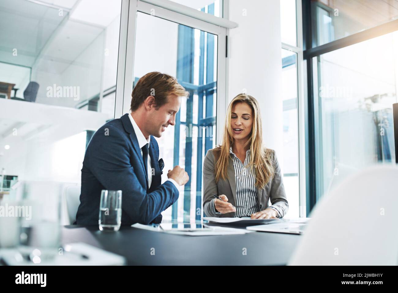 Heres a plan thatll definitely work. two businesspeople having a ...