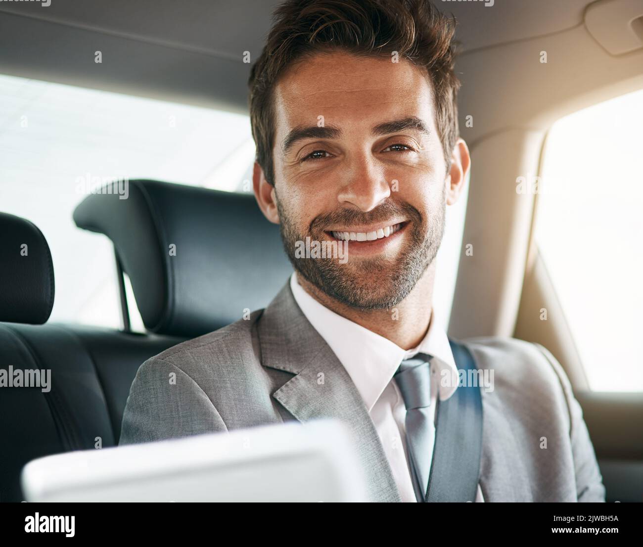 Bit of browsing before I clock in. a handsome young businessman using a ...