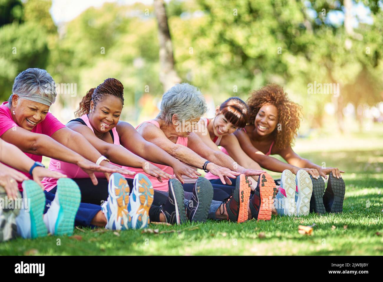 Stretching it out. a group of people warming up outdoors Stock Photo - Alamy