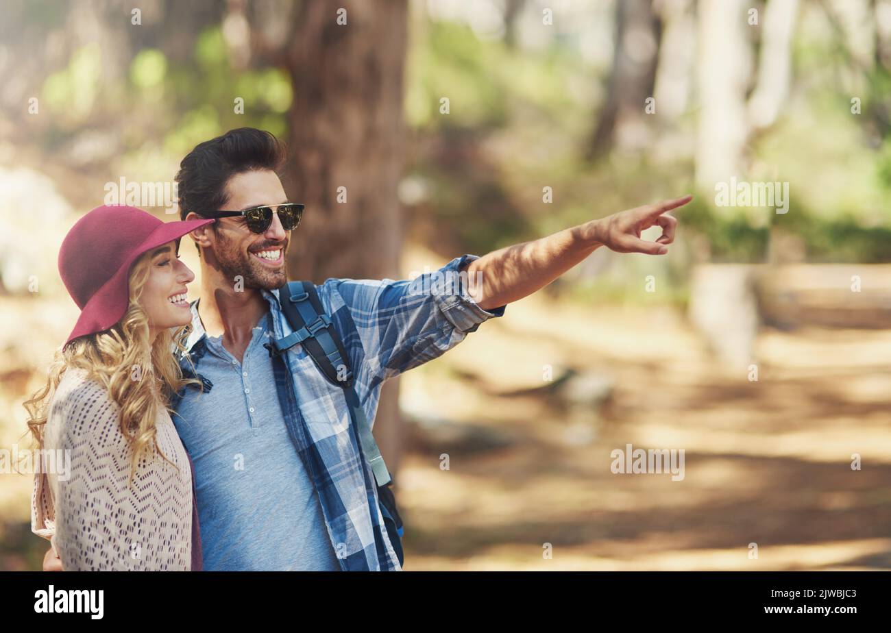 Take a look over there. an affectionate young couple during a hike ...