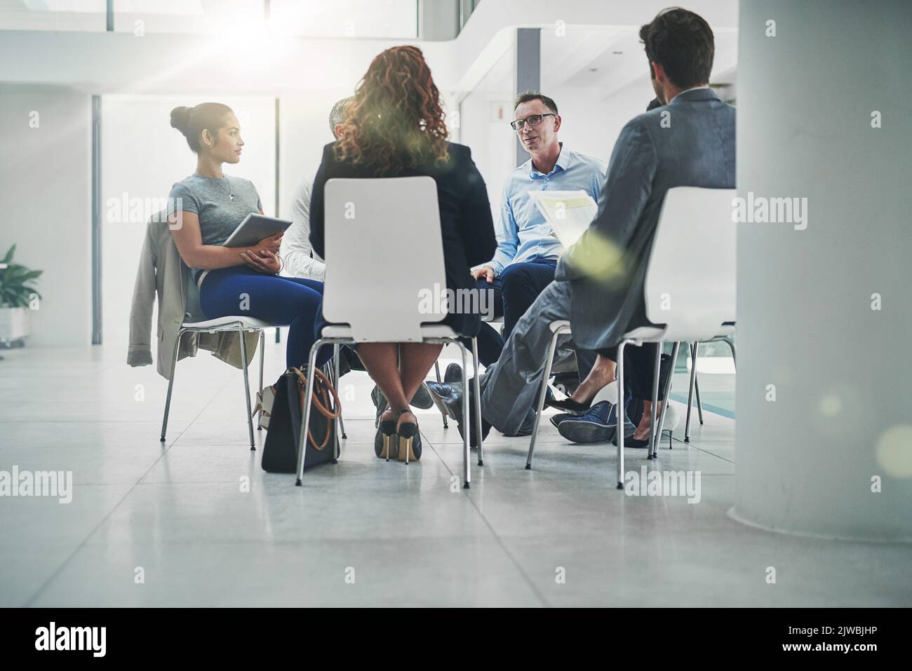 Planning is key to success. a group of coworkers talking together while ...