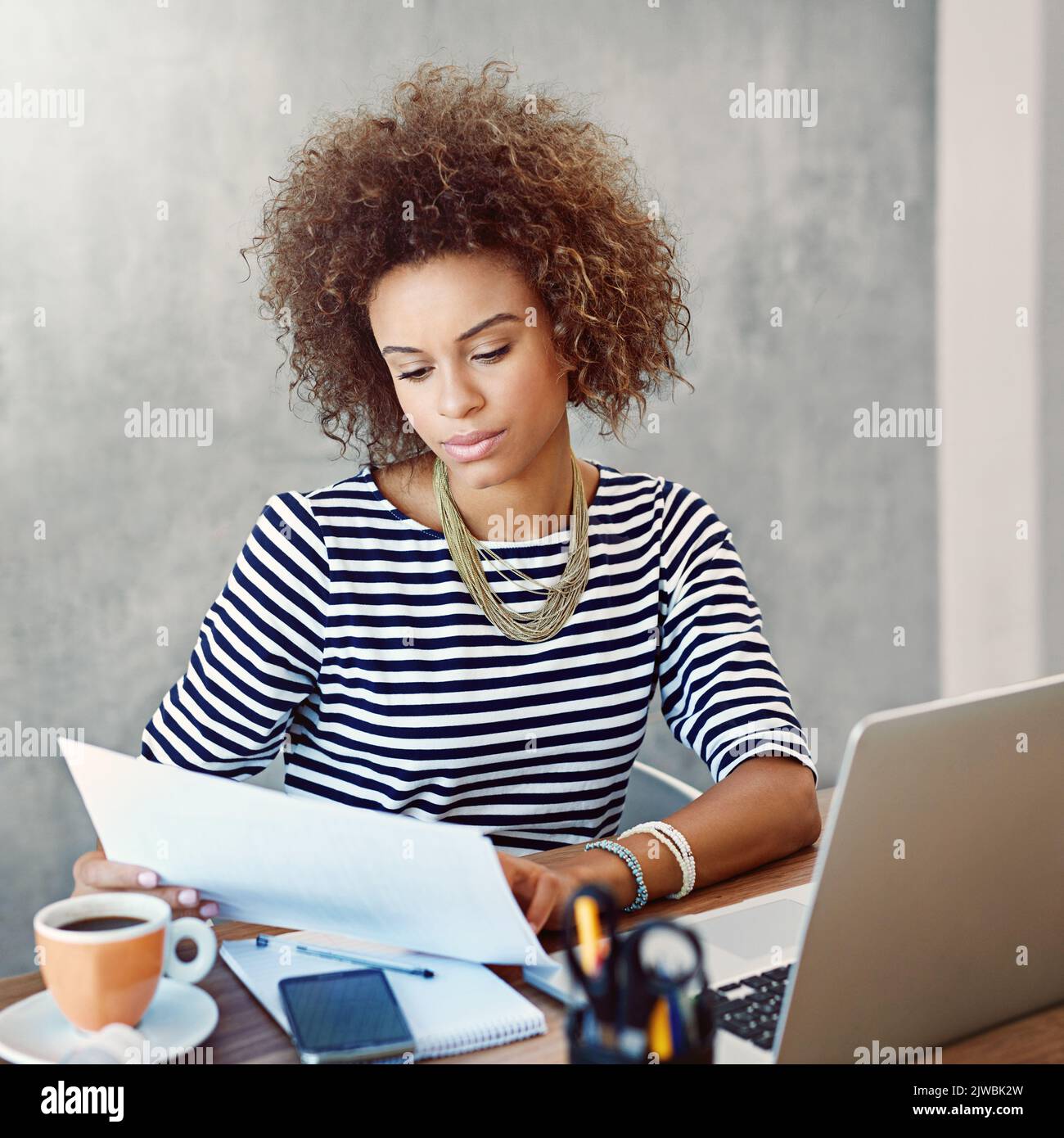 Organization is the key to running a business. a young woman working on ...