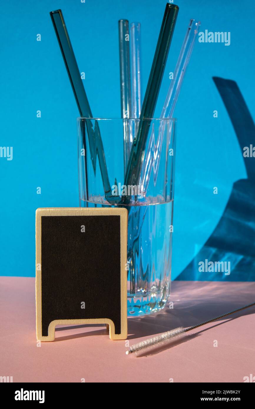 Reusable glass Straws in Glass with water on colorful background with ...