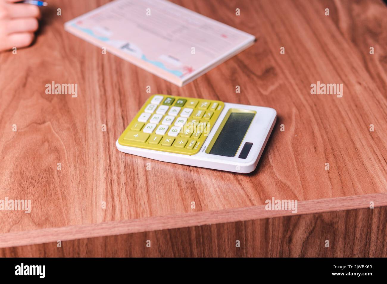 A wooden desk with a green calculator. High quality photo Stock Photo ...