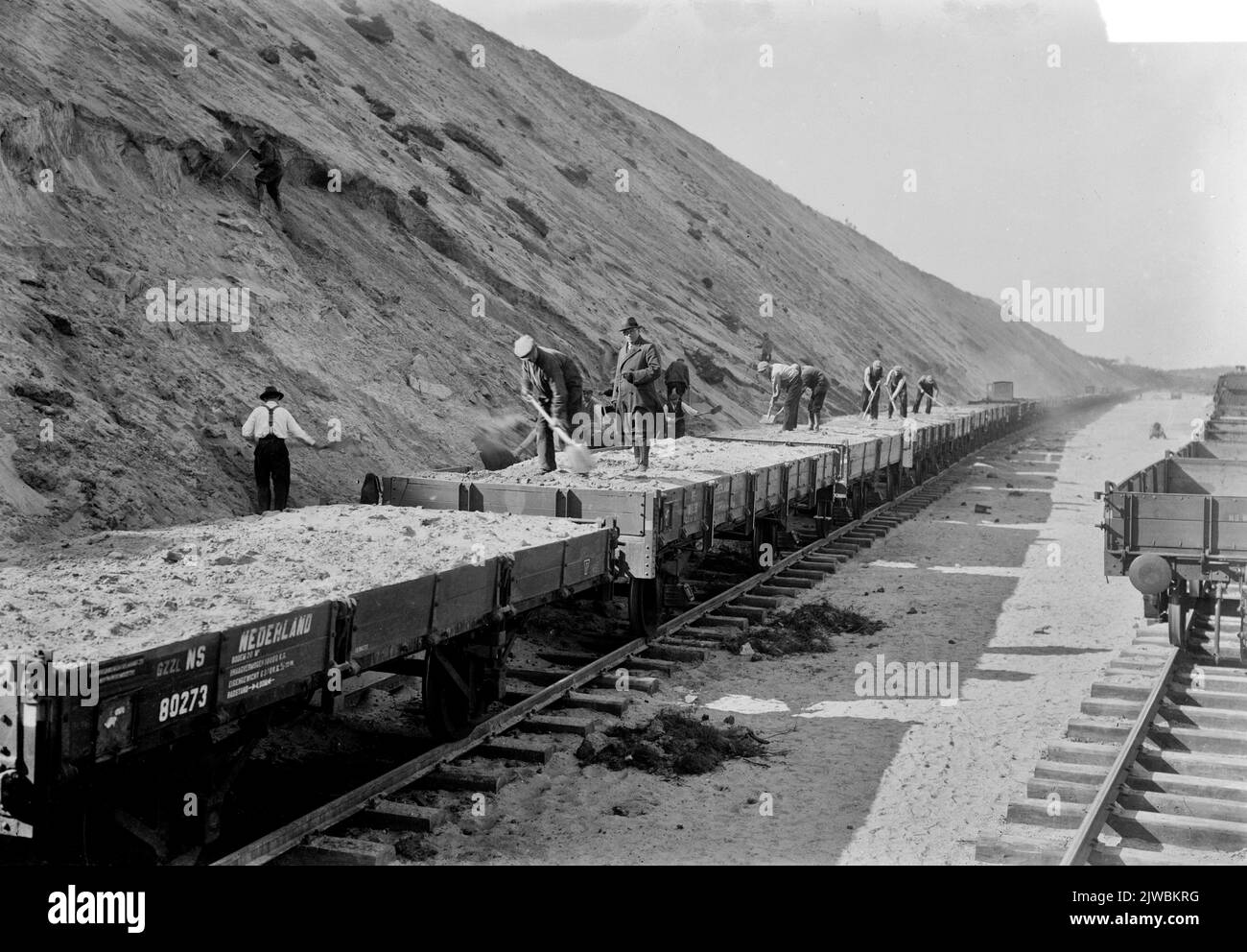 Image of the loading of a sand train in the context of the work ...