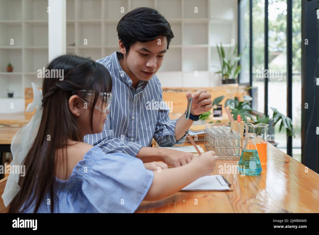 Kid and teacher doing science experiments. back to school concept Stock ...