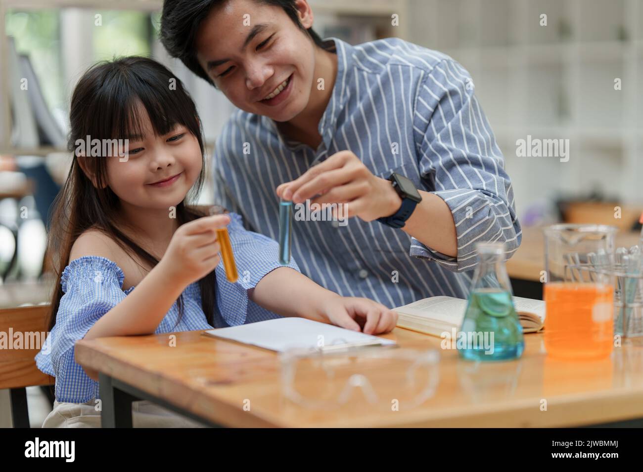 Kid and teacher doing science experiments. back to school concept Stock ...