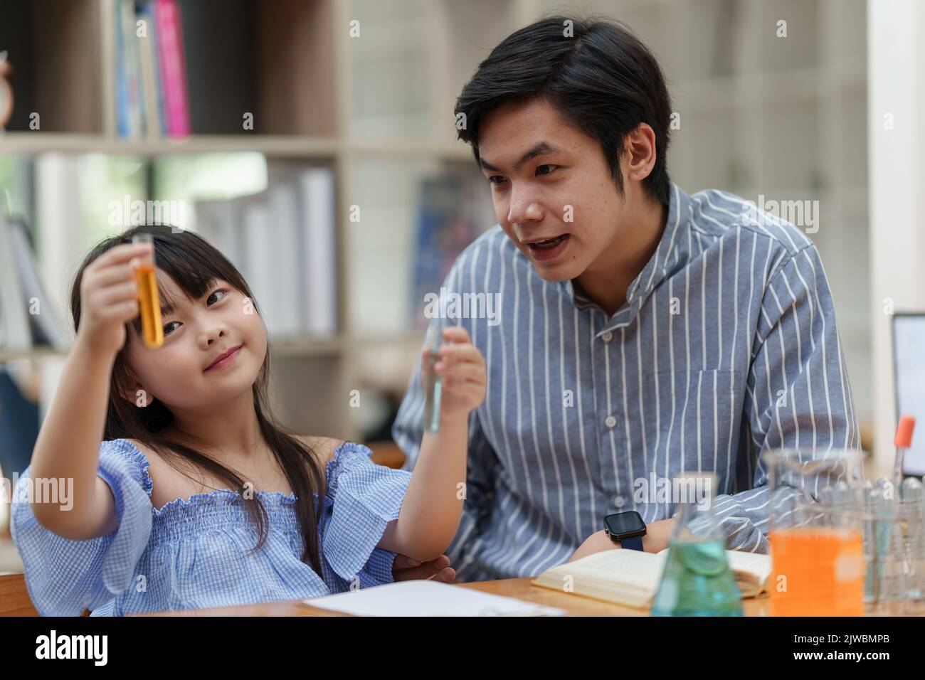 Kid and teacher doing science experiments. back to school concept Stock ...