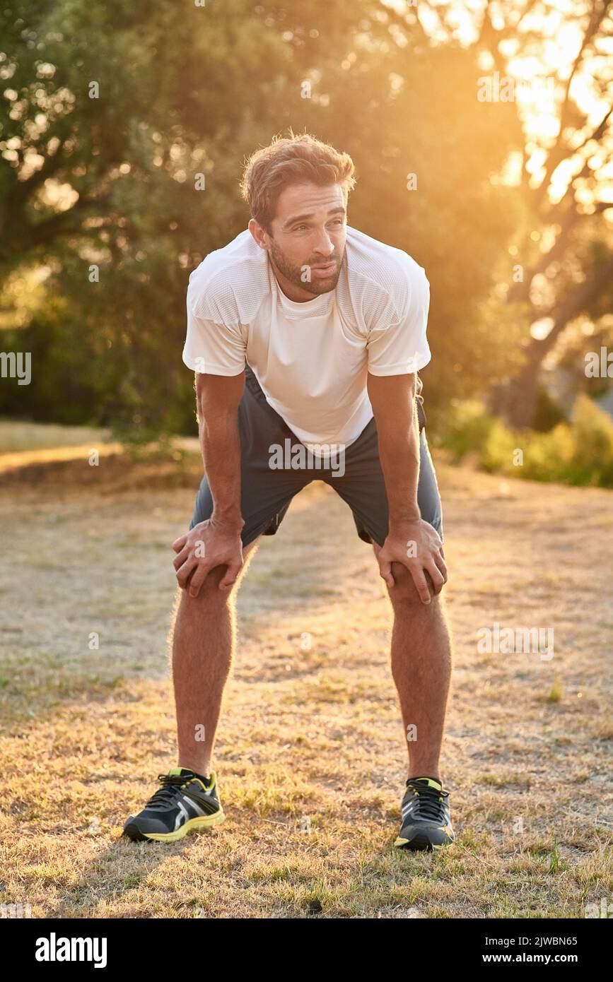 Pushing himself to the limit. a man taking a breather while out for a ...