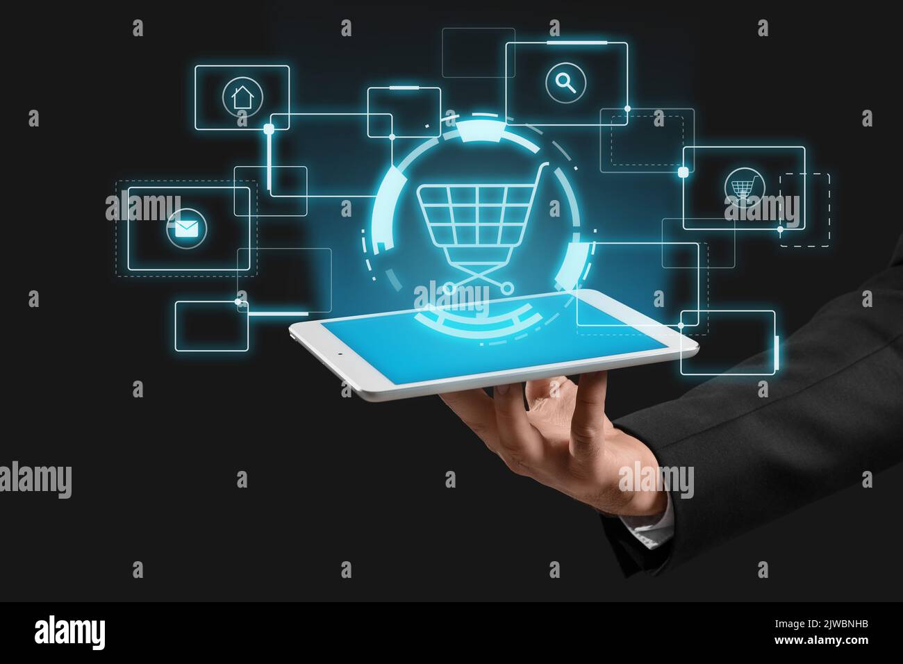 Hand of businessman with tablet computer on dark background. Online ...