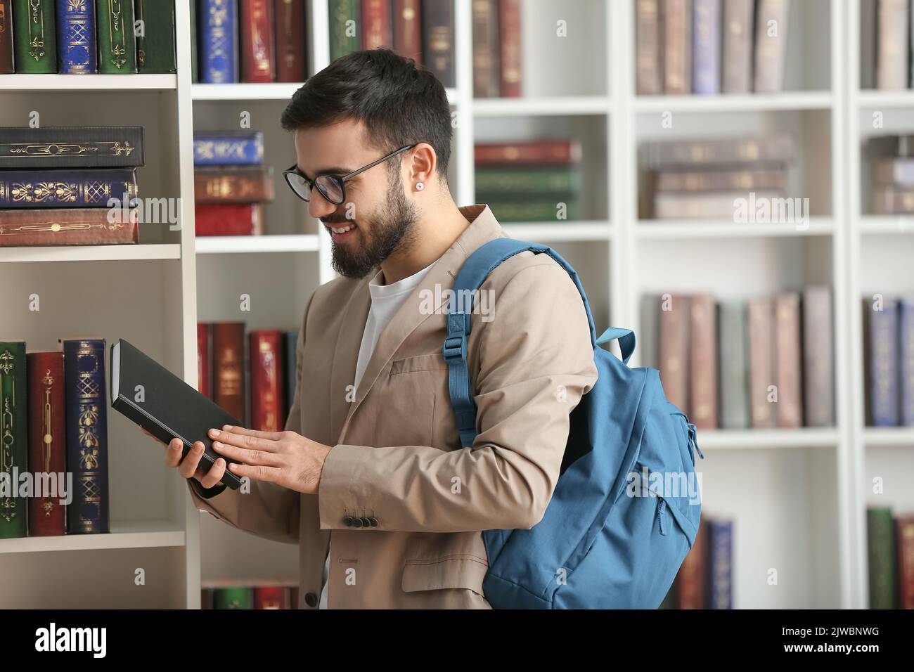 Young guy choosing books read hi-res stock photography and images - Alamy