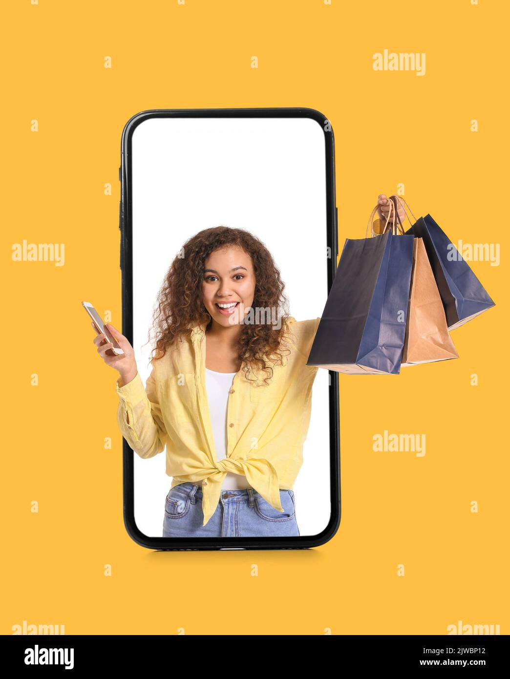 Beautiful African-American woman with bags looking out of smartphone ...