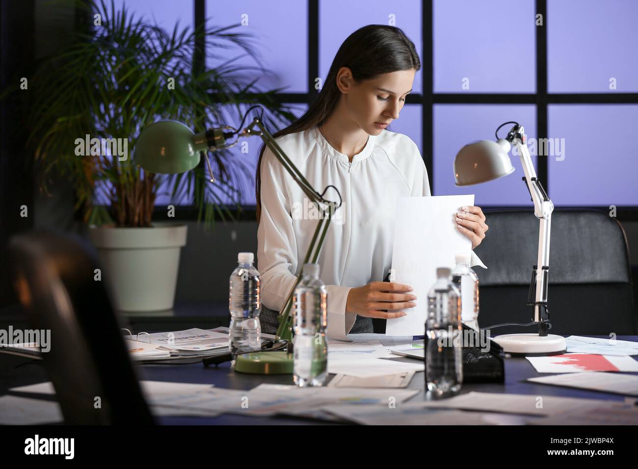 Beautiful businesswoman working with document in office at night Stock ...