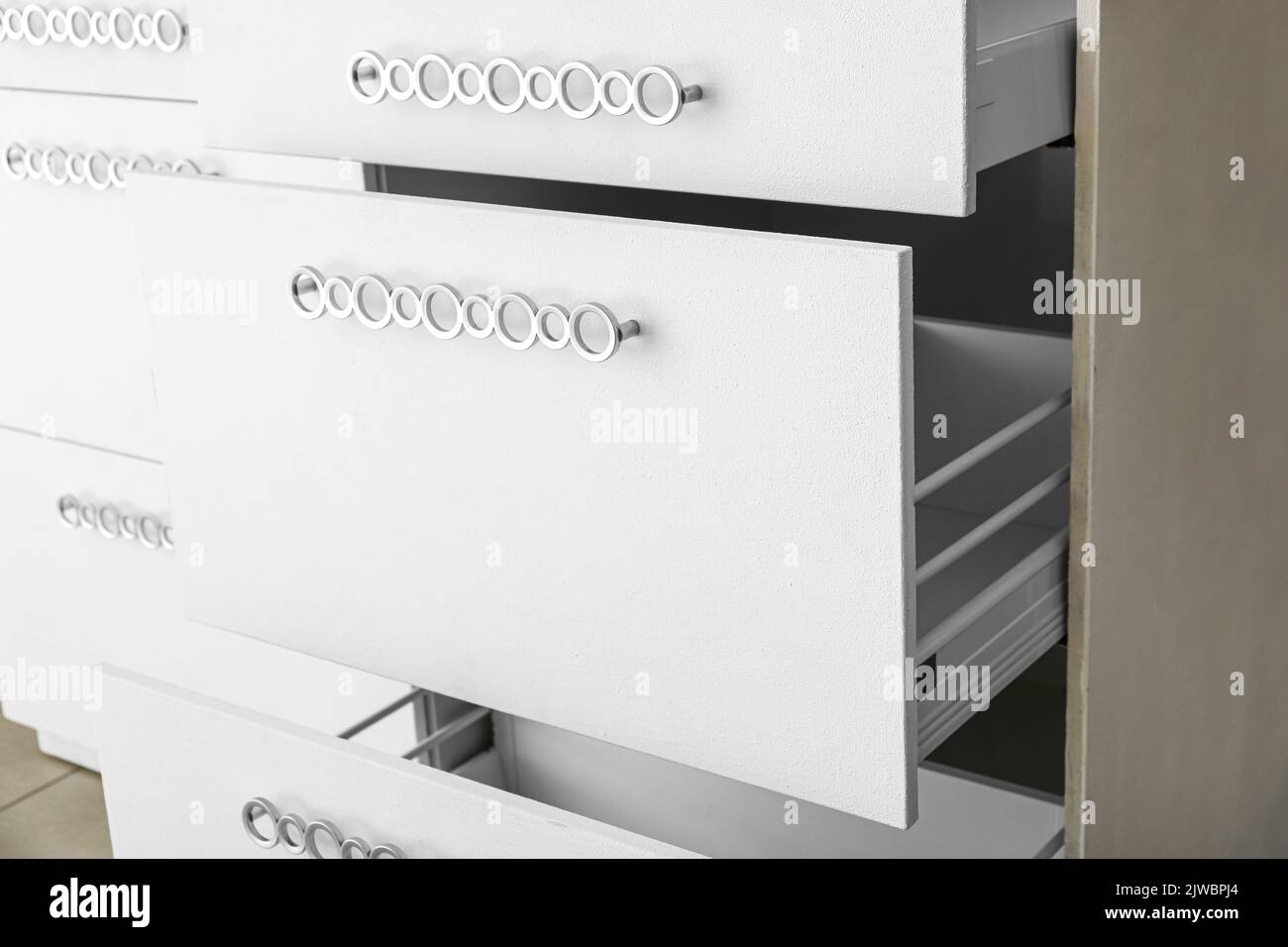 Open empty drawers in kitchen, closeup Stock Photo - Alamy