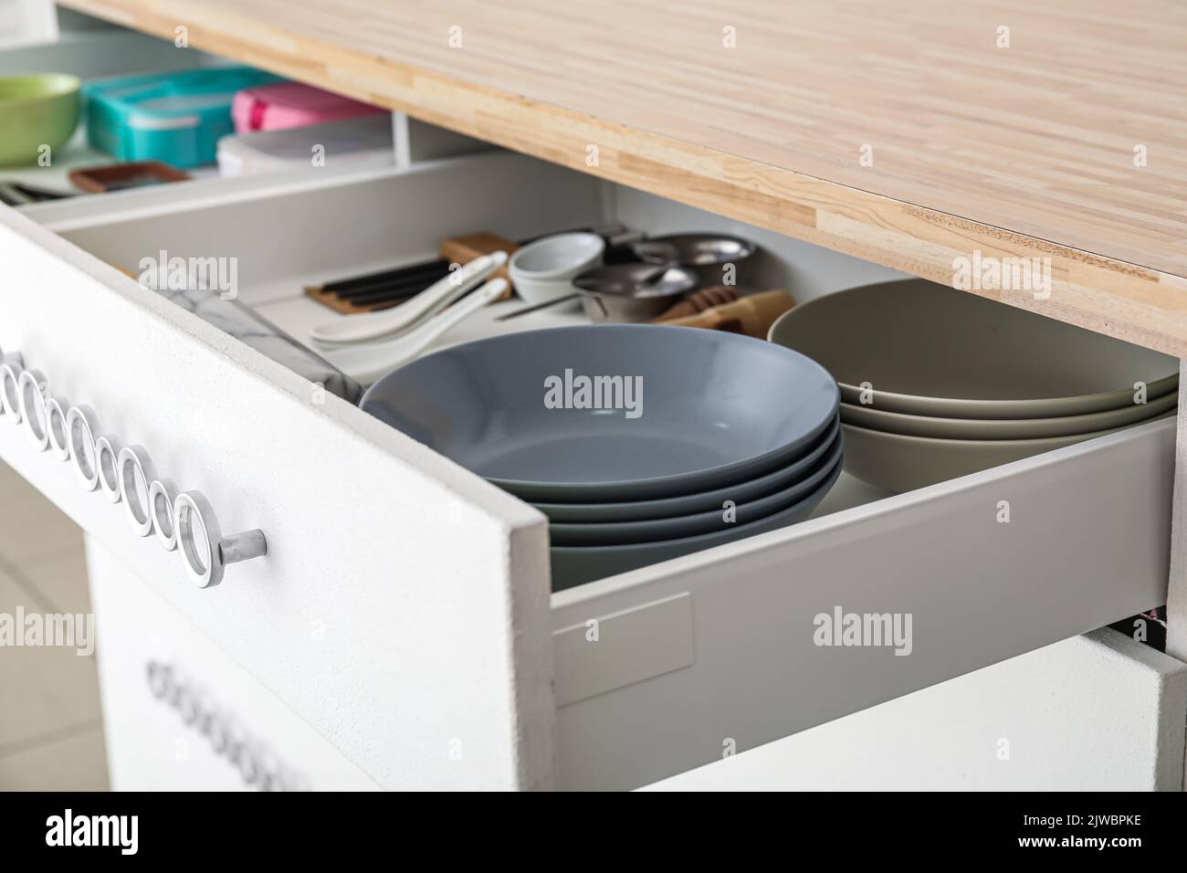 Open drawer with utensils in kitchen, closeup Stock Photo - Alamy