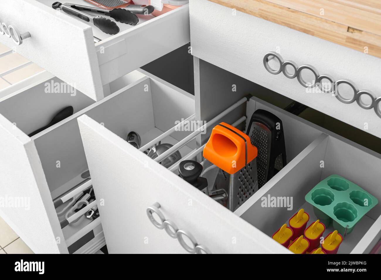 Open drawers with utensils in kitchen, closeup Stock Photo - Alamy