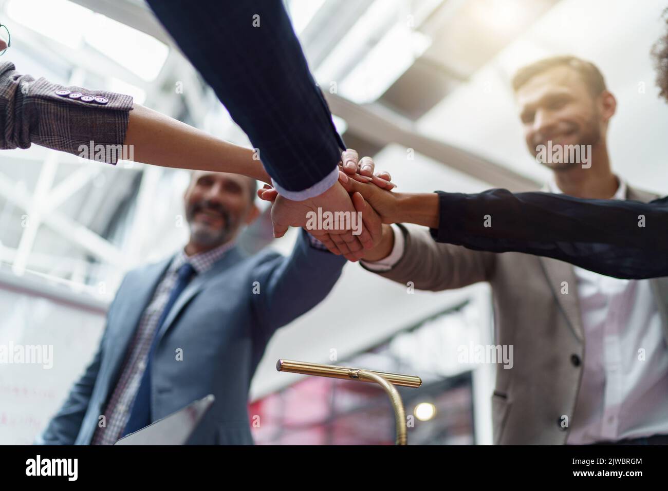 Happy group of business coworkers stacked hands together as concept of ...