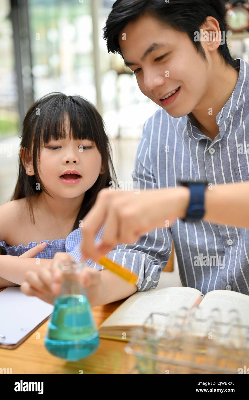 Portrait, Cute young Asian girl is excited and enjoying doing a science ...