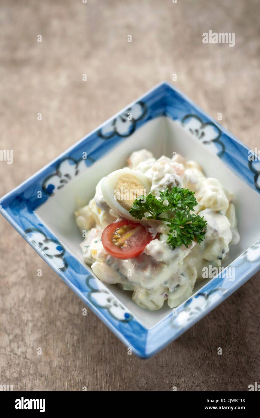 potato and egg salad Ensalada Rusa tapas in rustic spanish restaurant ...