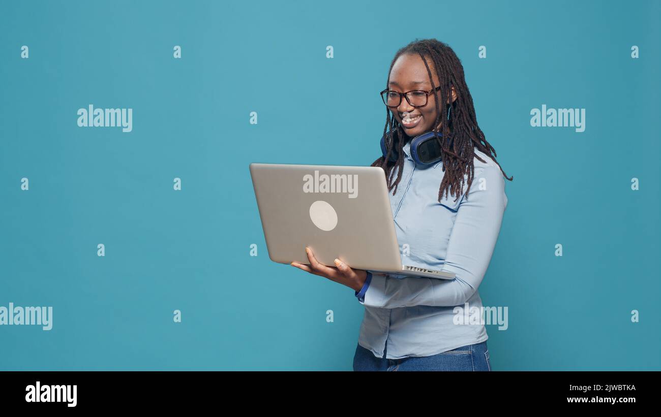 African american person browsing internet on laptop, using computer to ...