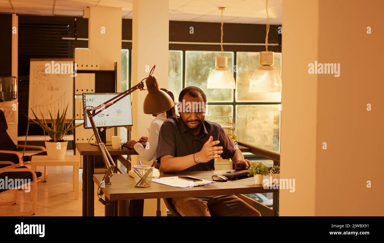 Impatient employee checking time on wristwatch at office job during ...