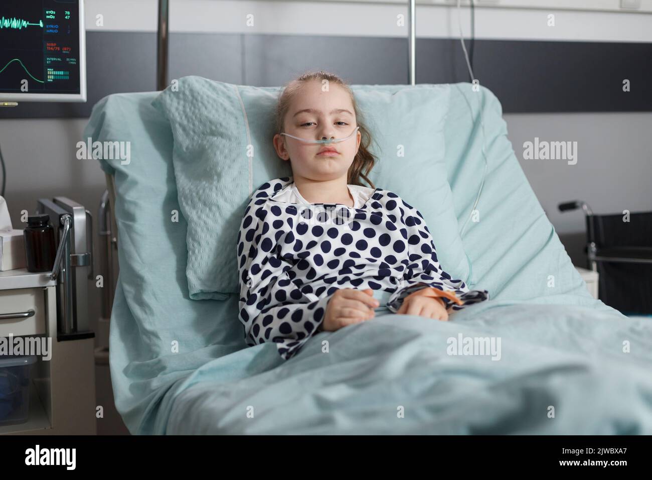 Hospitalized sick little girl resting in children healthcare clinic ...