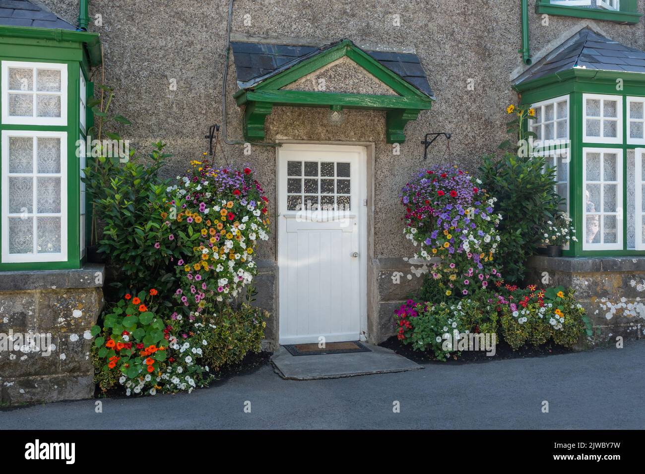 Flowers at the front door of a traditional house in the village of Cong ...