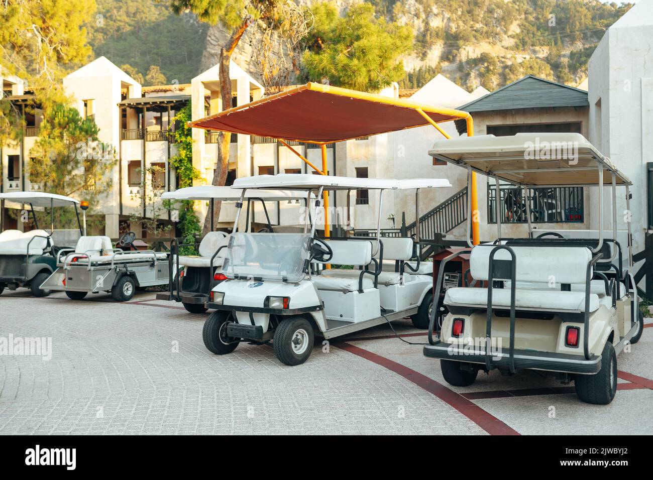 Electrical golf cars parked on a road Stock Photo - Alamy